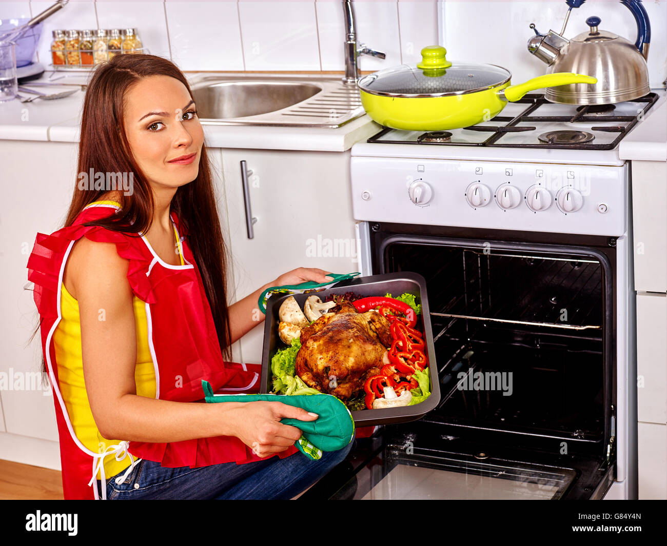 Woman cooking chicken at kitchen Stock Photo - Alamy