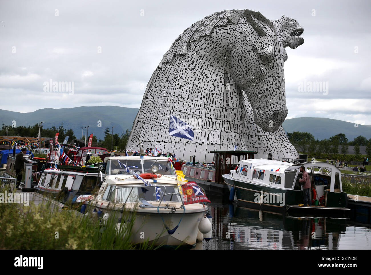A Boater throws a rope from his barge on the Forth and Clyde Canal ...