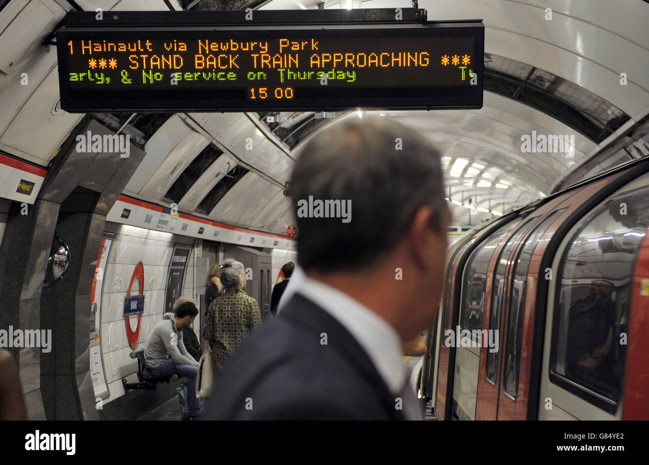 Commuters wait for a Central Line train at Bank station, London, on the ...