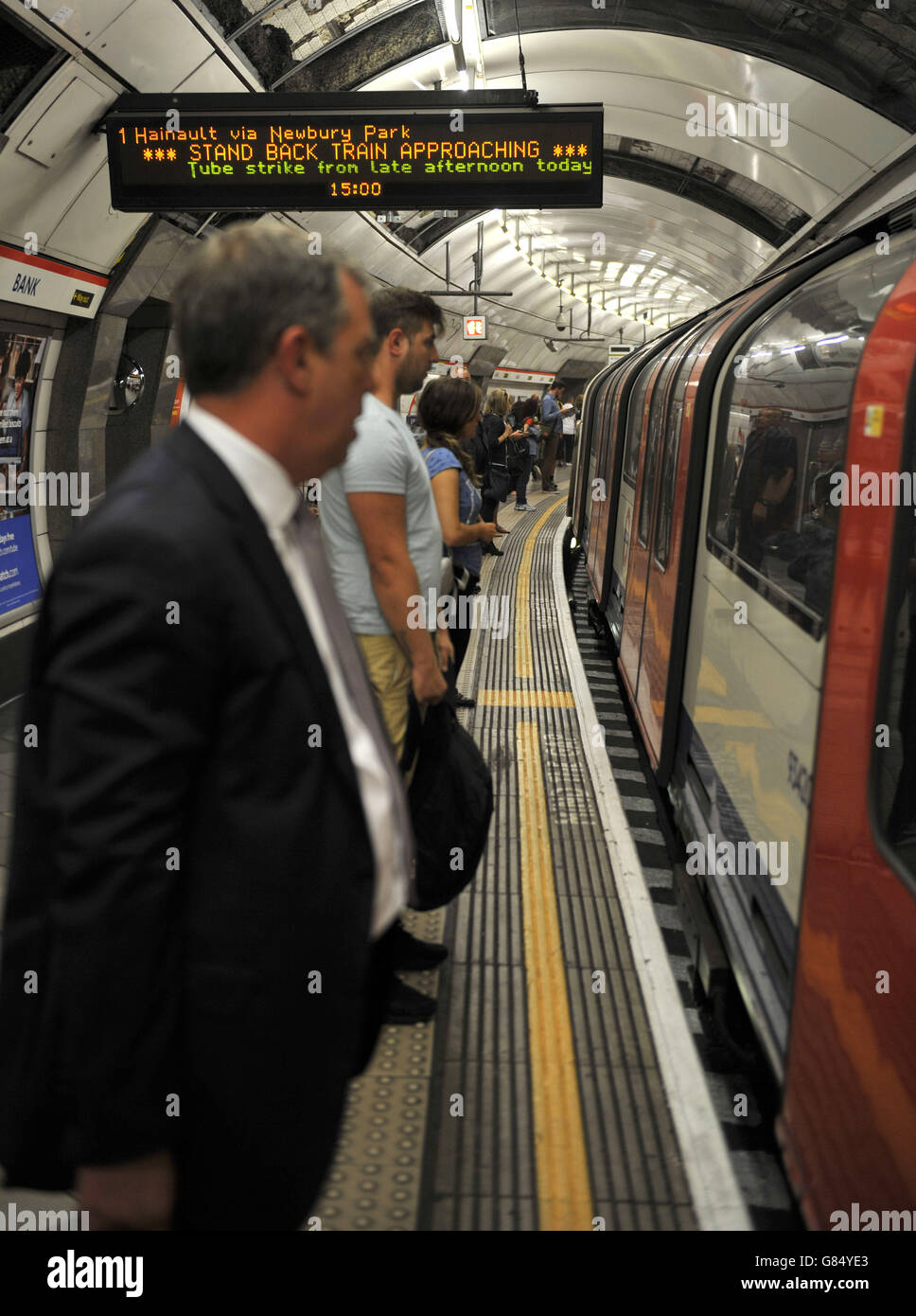 Commuters wait for a Central Line train at Bank station, London, on the ...