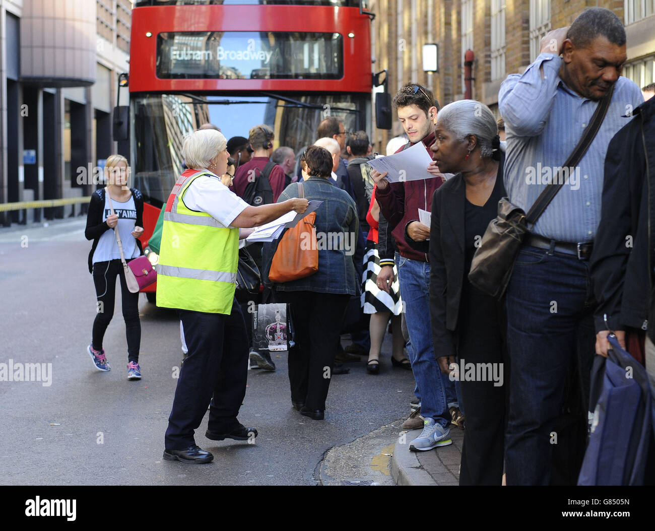 People queue for buses outside Liverpool Street Station, London, as ...