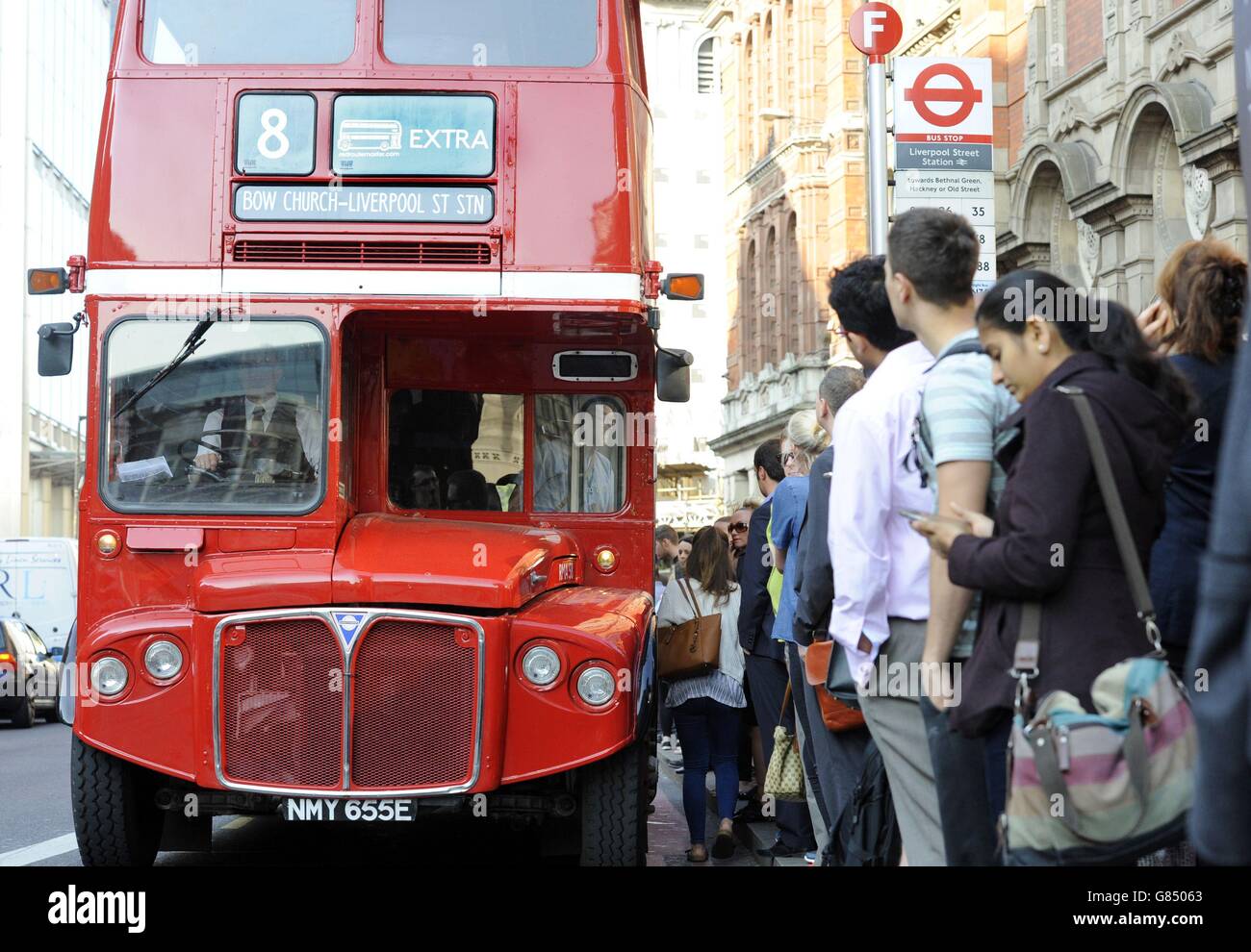 People queue for buses outside Liverpool Street Station, London, as ...