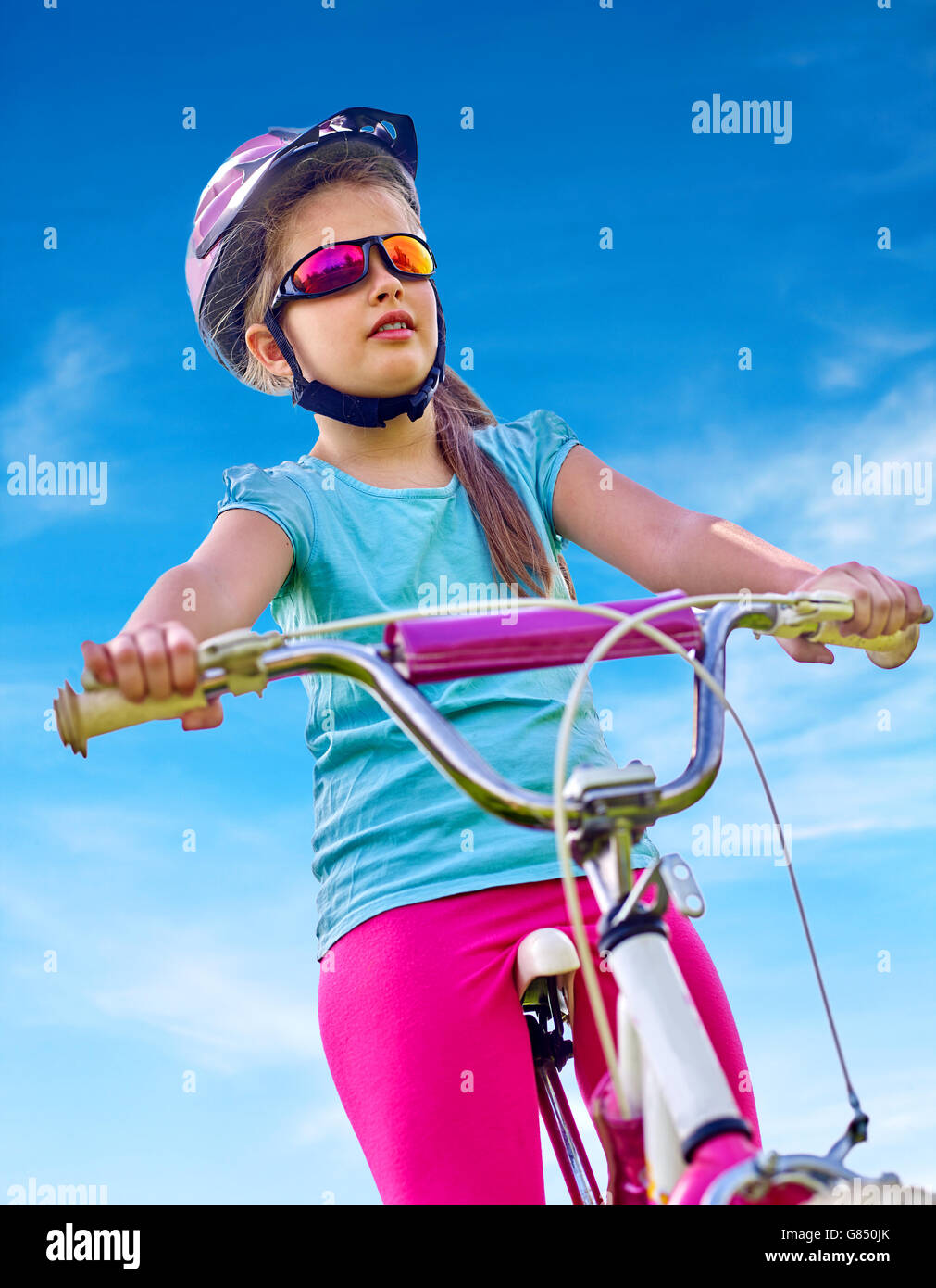 Bikes cycling girl wearing helmet rides bicycle Stock Photo - Alamy