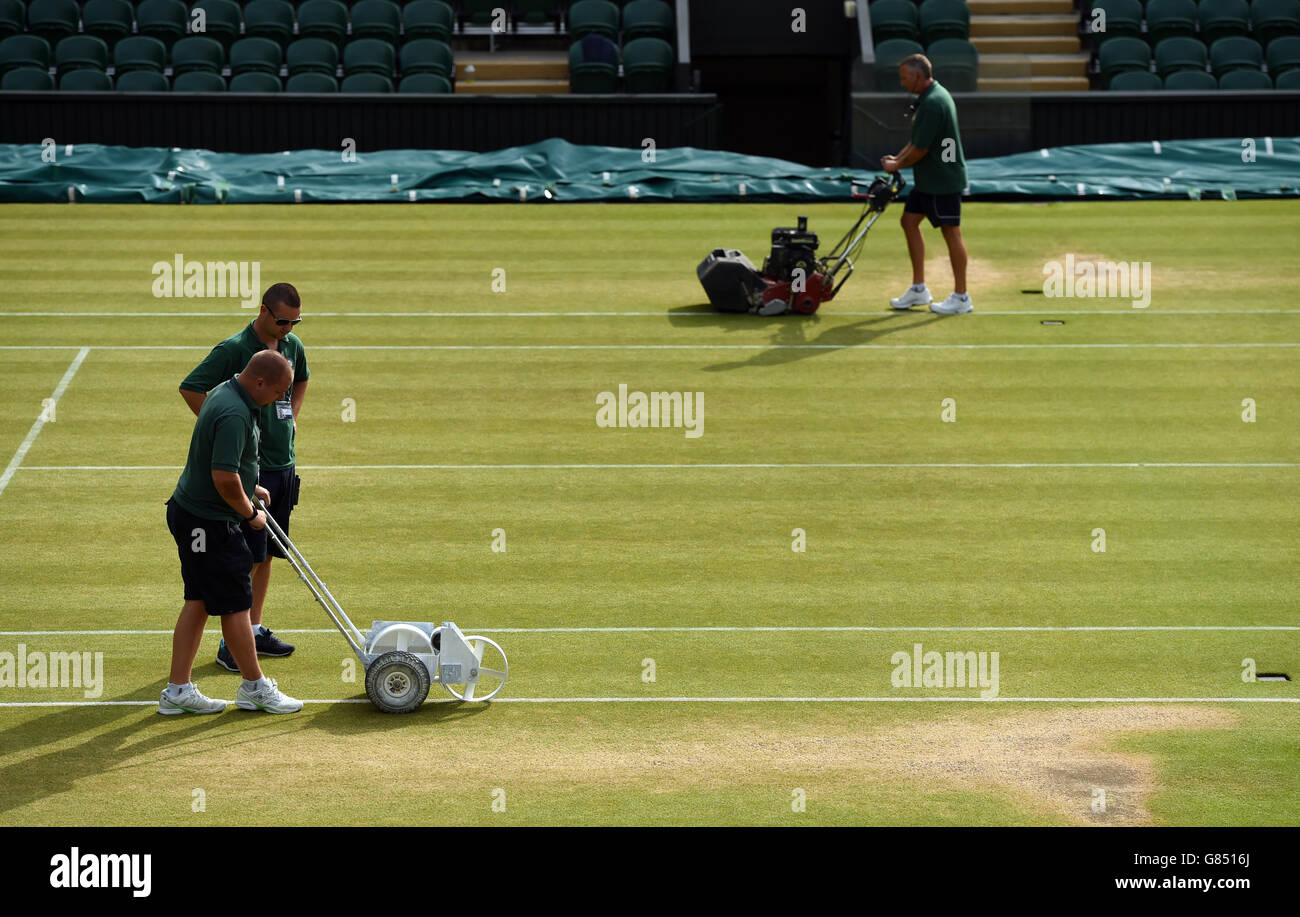 Ground staff put the finishing touches to centre court on day Thirteen ...