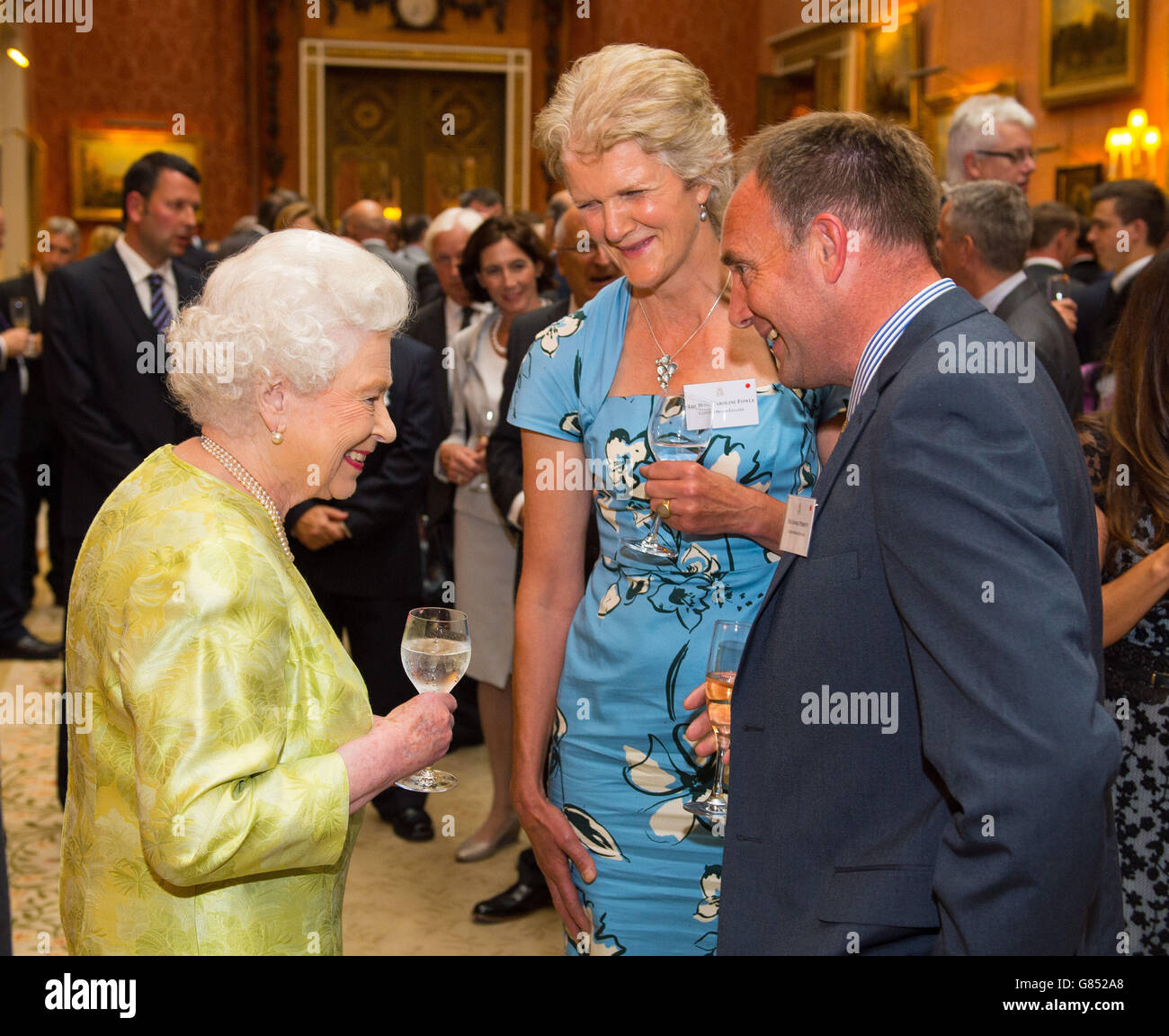 Queen Elizabeth II meets Caroline Fowle and George Perrott (right) of ...
