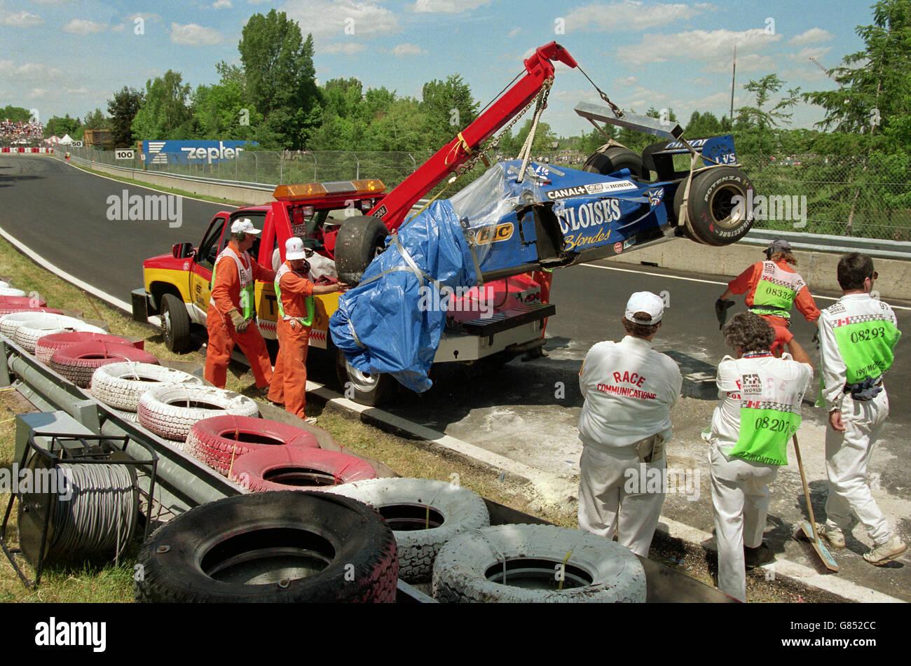 Marshalls clear the wreckage of Olivier Panis's crashed car Stock Photo ...