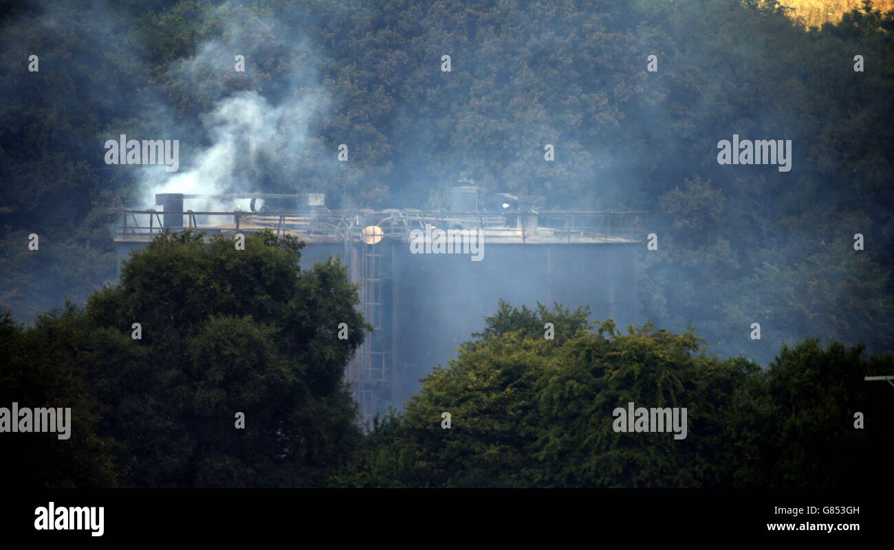 Smoke rises from the scene of an explosion and fire where four people ...
