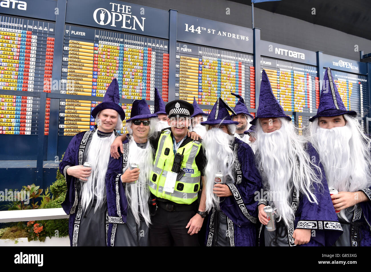 A group of golf fans in fancy dress pose for a photo with a Polie ...