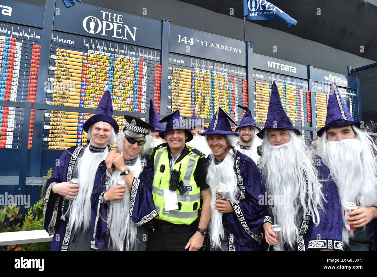 A group of golf fans in fancy dress pose for a photo with a Polie ...