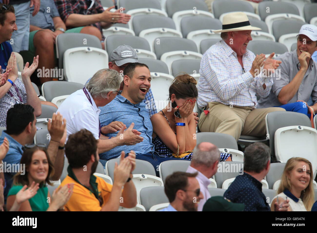 A woman in the crowd shows her embarrassment after fall off her seat ...