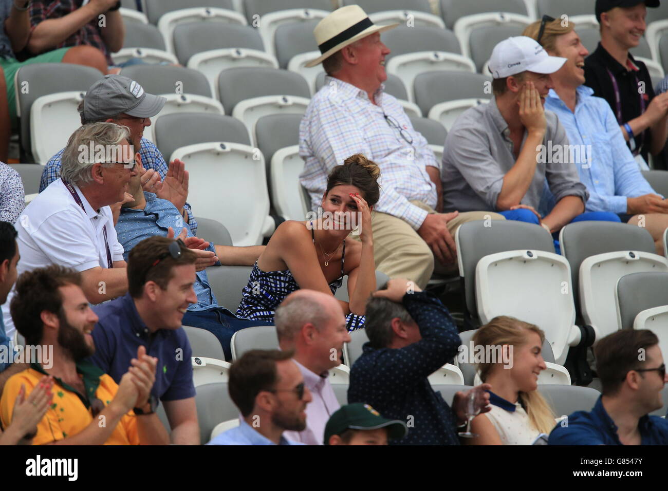 A woman in the crowd shows her embarrassment after fall off her seat ...