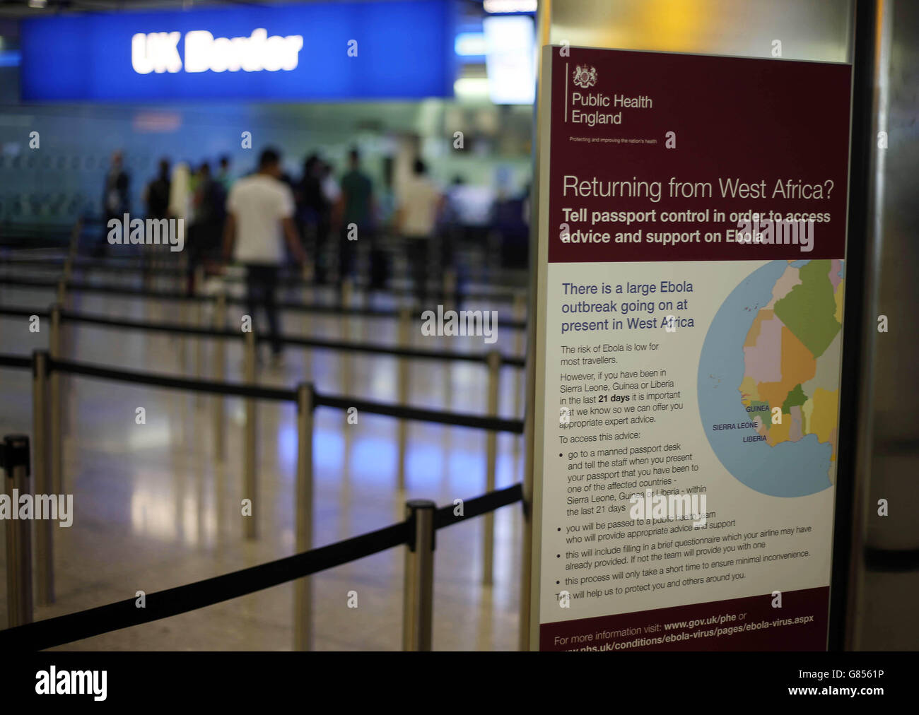 A sign about Ebola on view as passengers pass through UK Border at ...