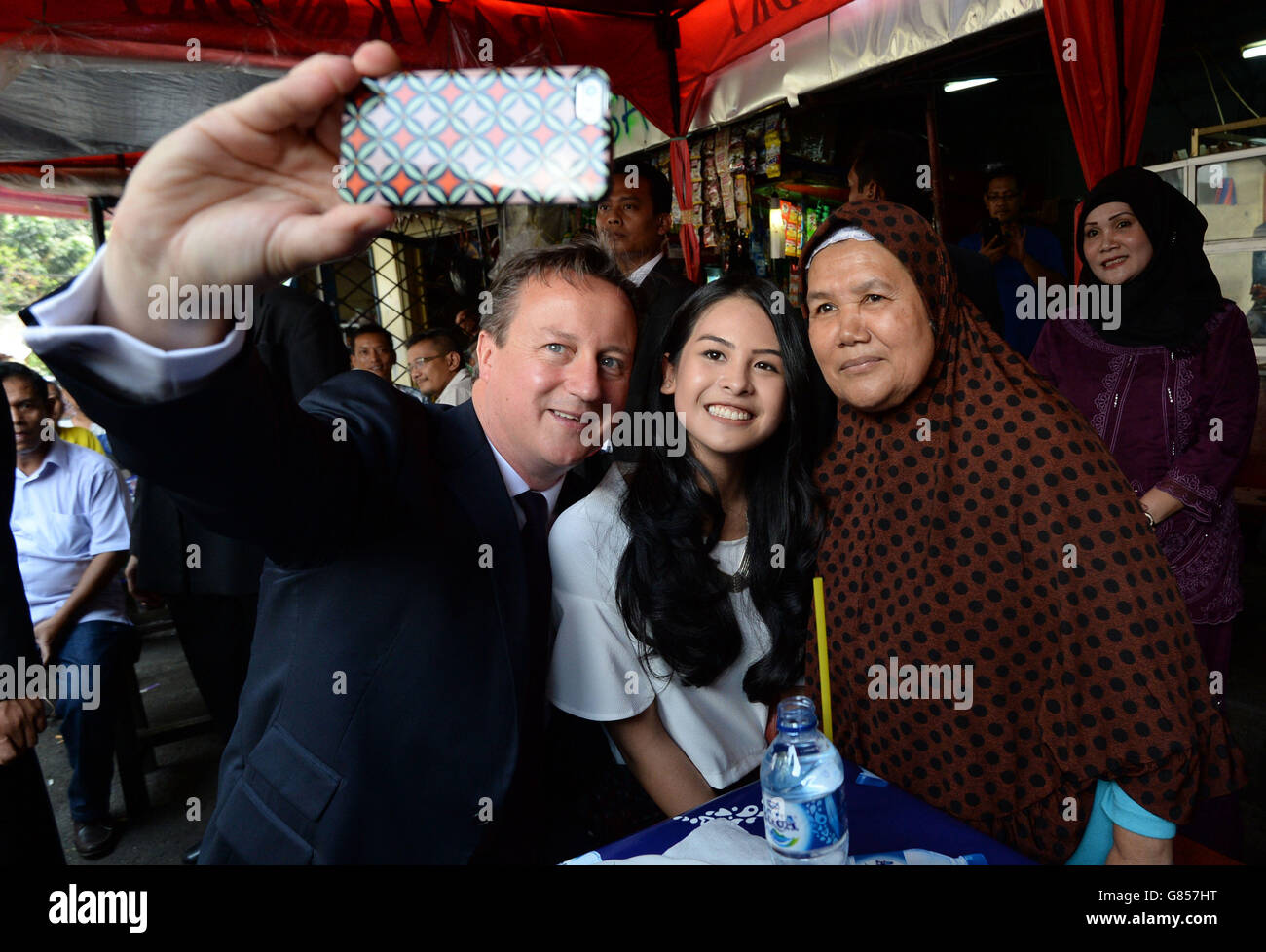 Prime Minister David Cameron takes a selfie as he is shown around a ...