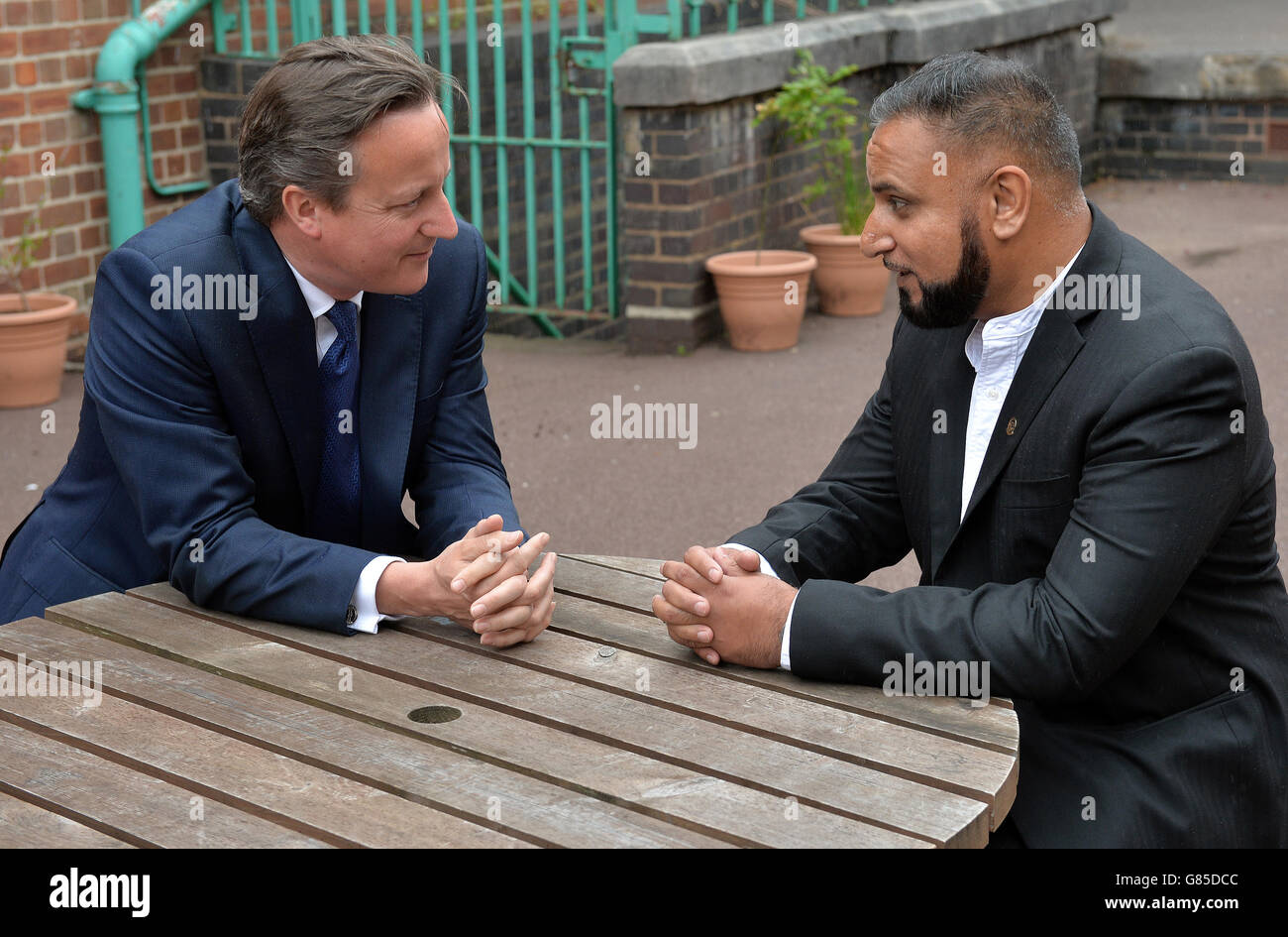 Prime Minister David Cameron speaks with Abdullah Rehman before ...