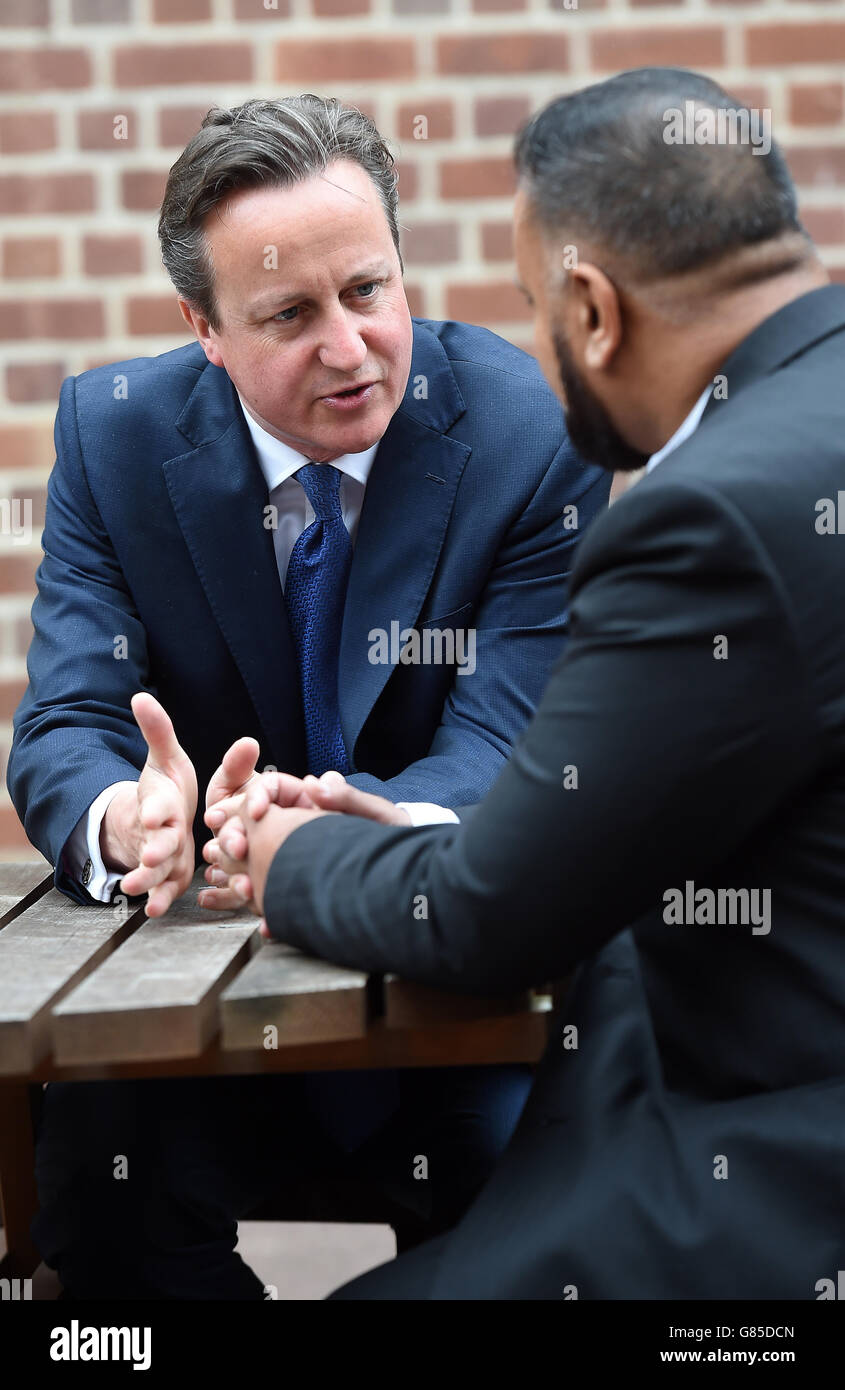 Prime Minister David Cameron speaks with Abdullah Rehman before ...