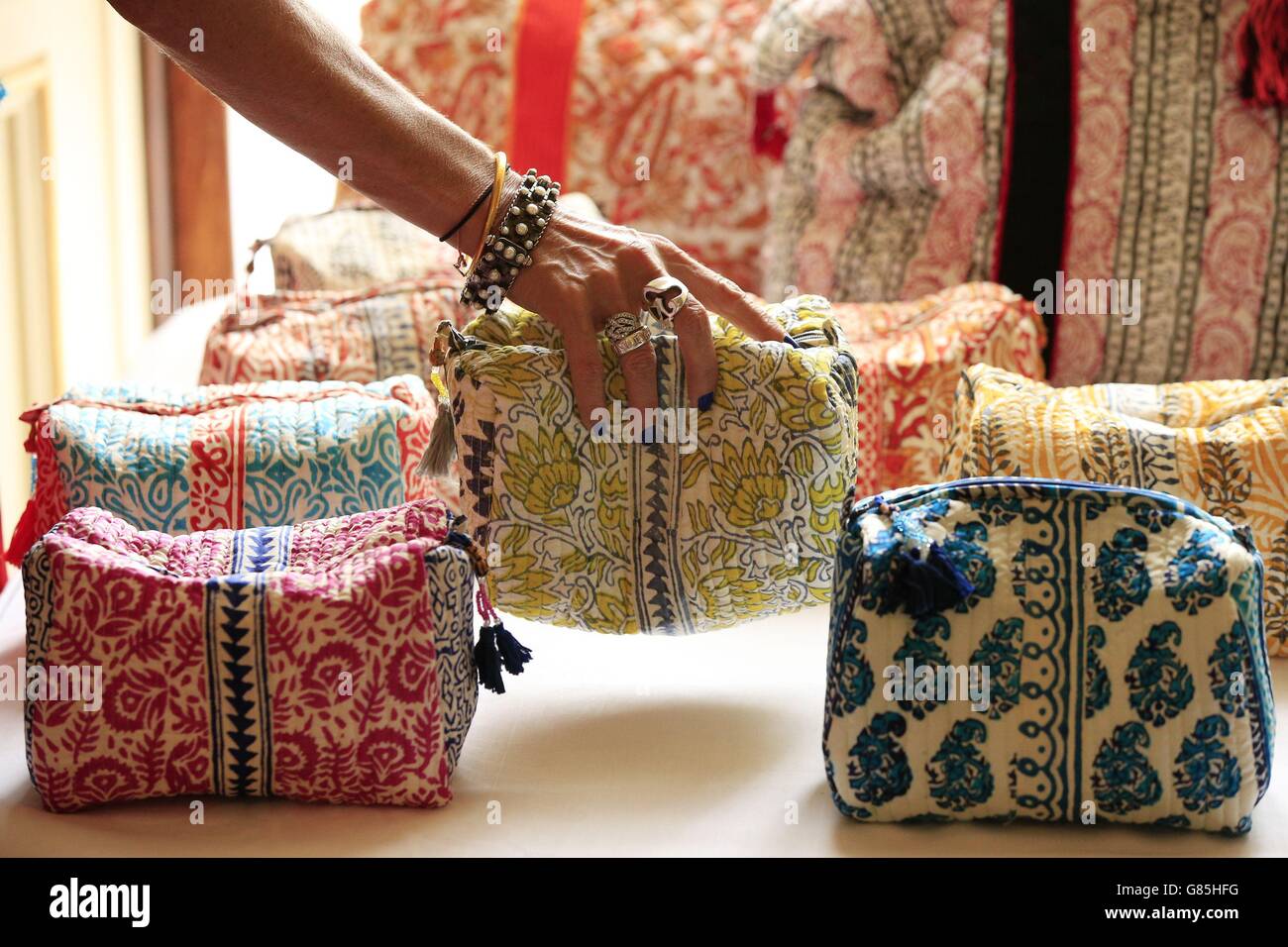 A guest looks at garments and accessories created by women escaping ...