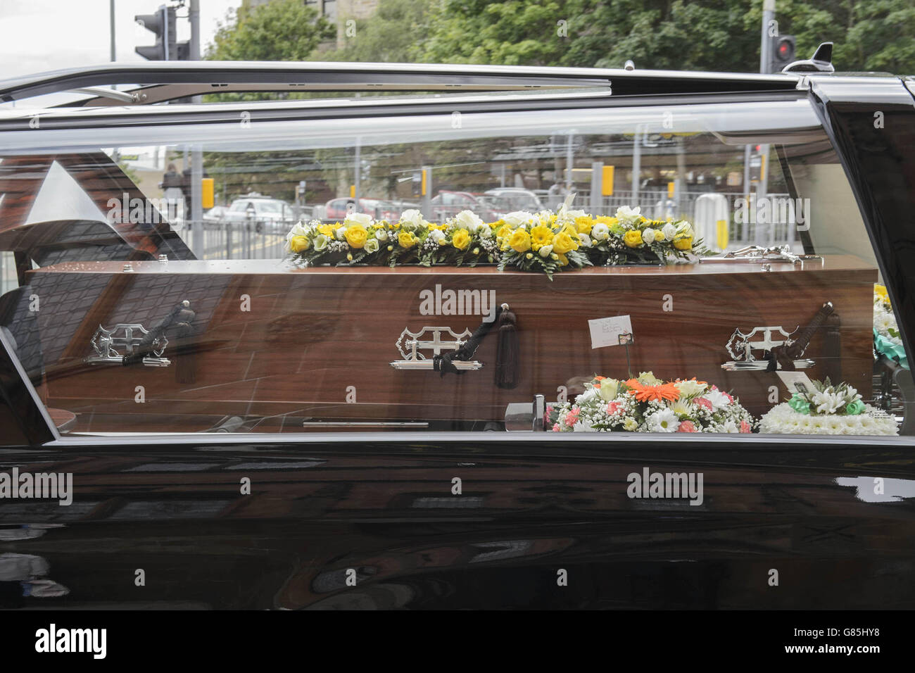 A hearse carrying the coffin of John Yuill following his funeral at St ...