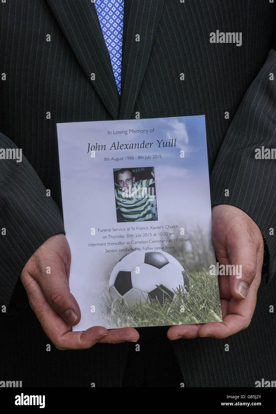 A man holds the order of service during the funeral of John Yuill at St ...