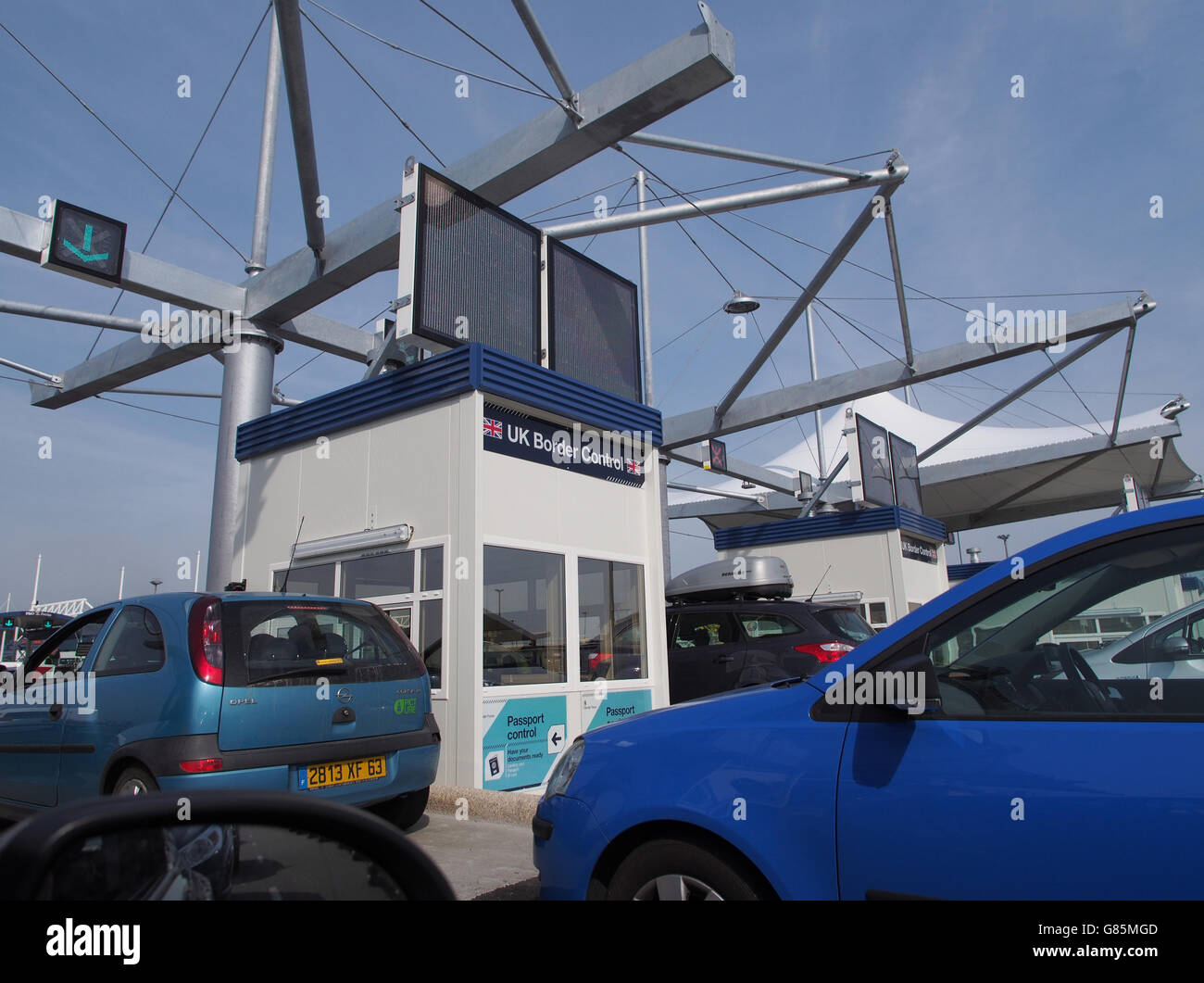 Cars driving through UK Border Control checkpoints at Calais ferry port ...