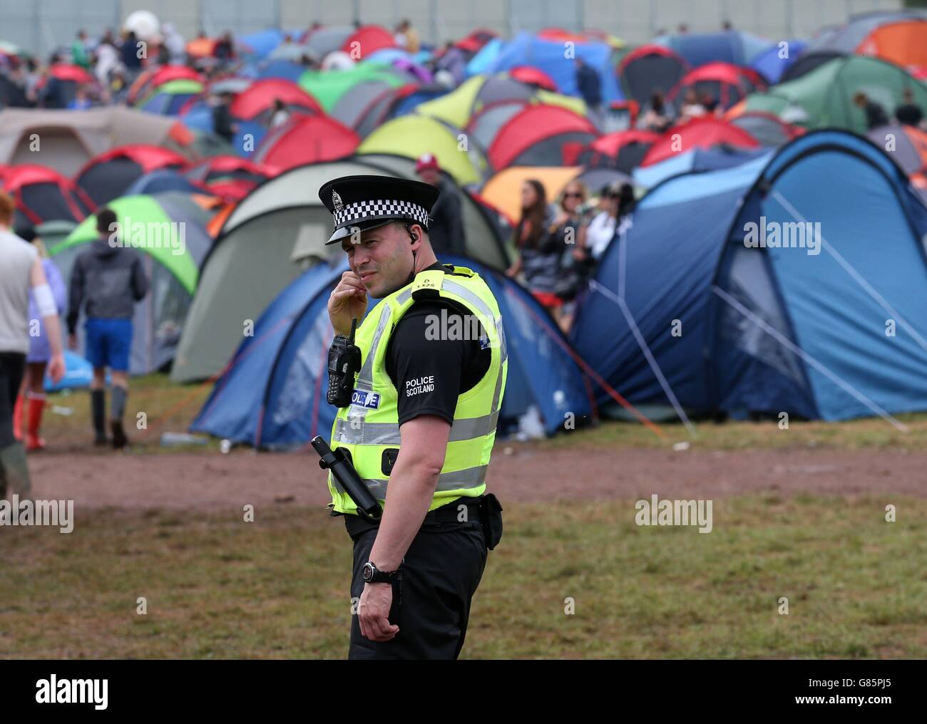 A police officer patrols in the campsite at the main stage at the T in ...