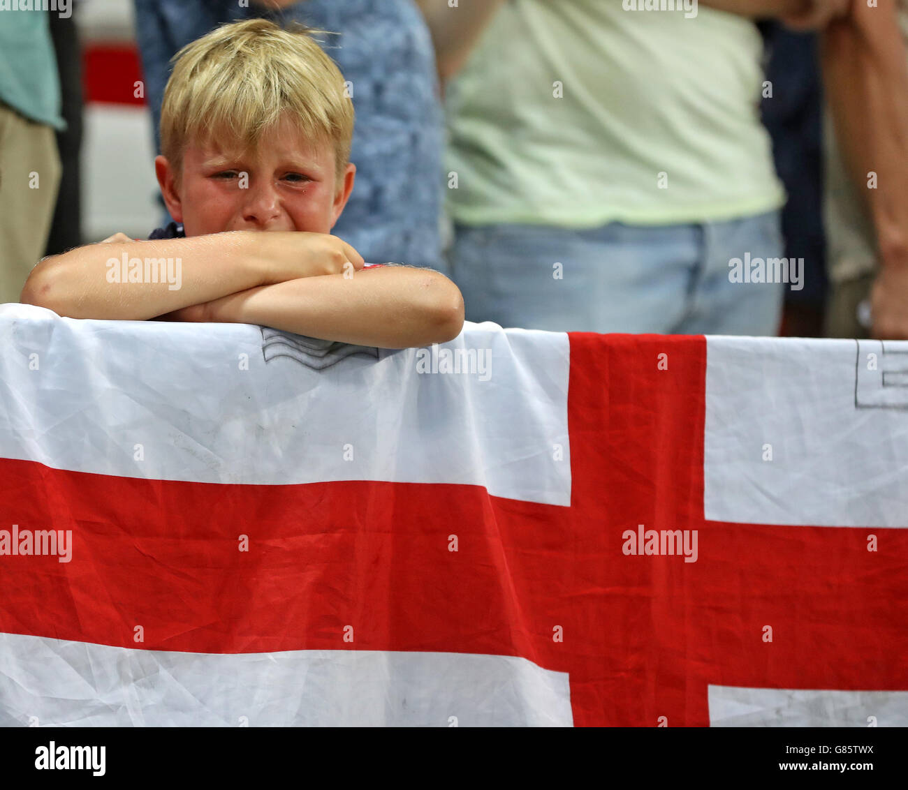 A young England fan looks dejected after the final whistle following ...