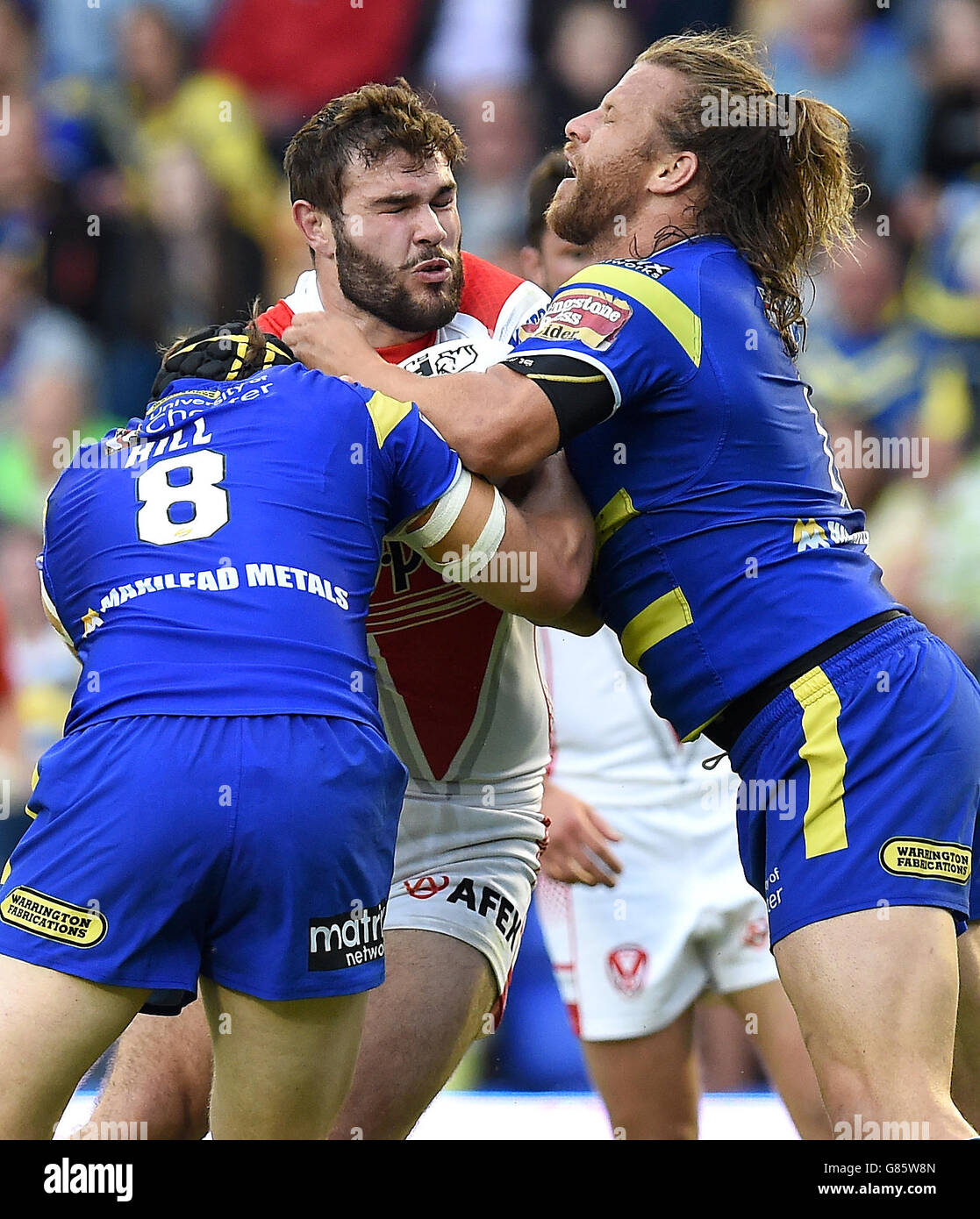St Helens Alex Walmsley is tacked by Warrington Wolves' Chris Hill ...