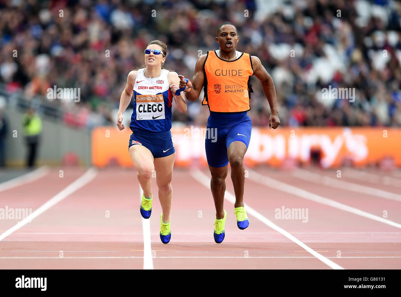 Libby Clegg wins the 200m T12 with guide Mikail Huggins during day ...