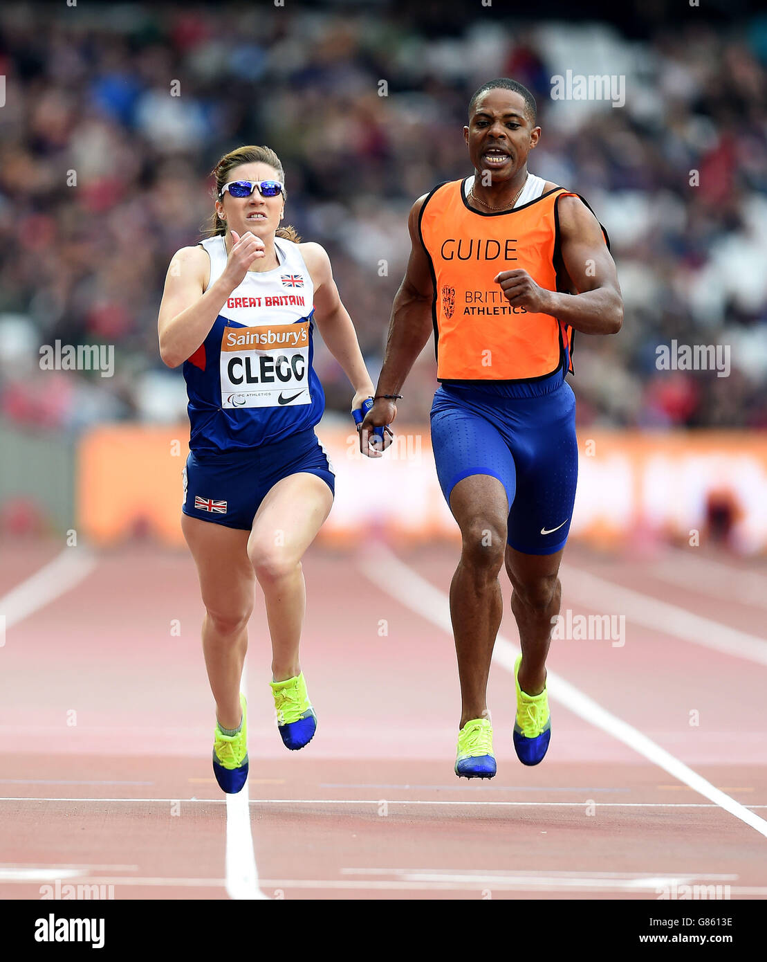 Libby Clegg wins the 200m T12 with guide Mikail Huggins during day ...