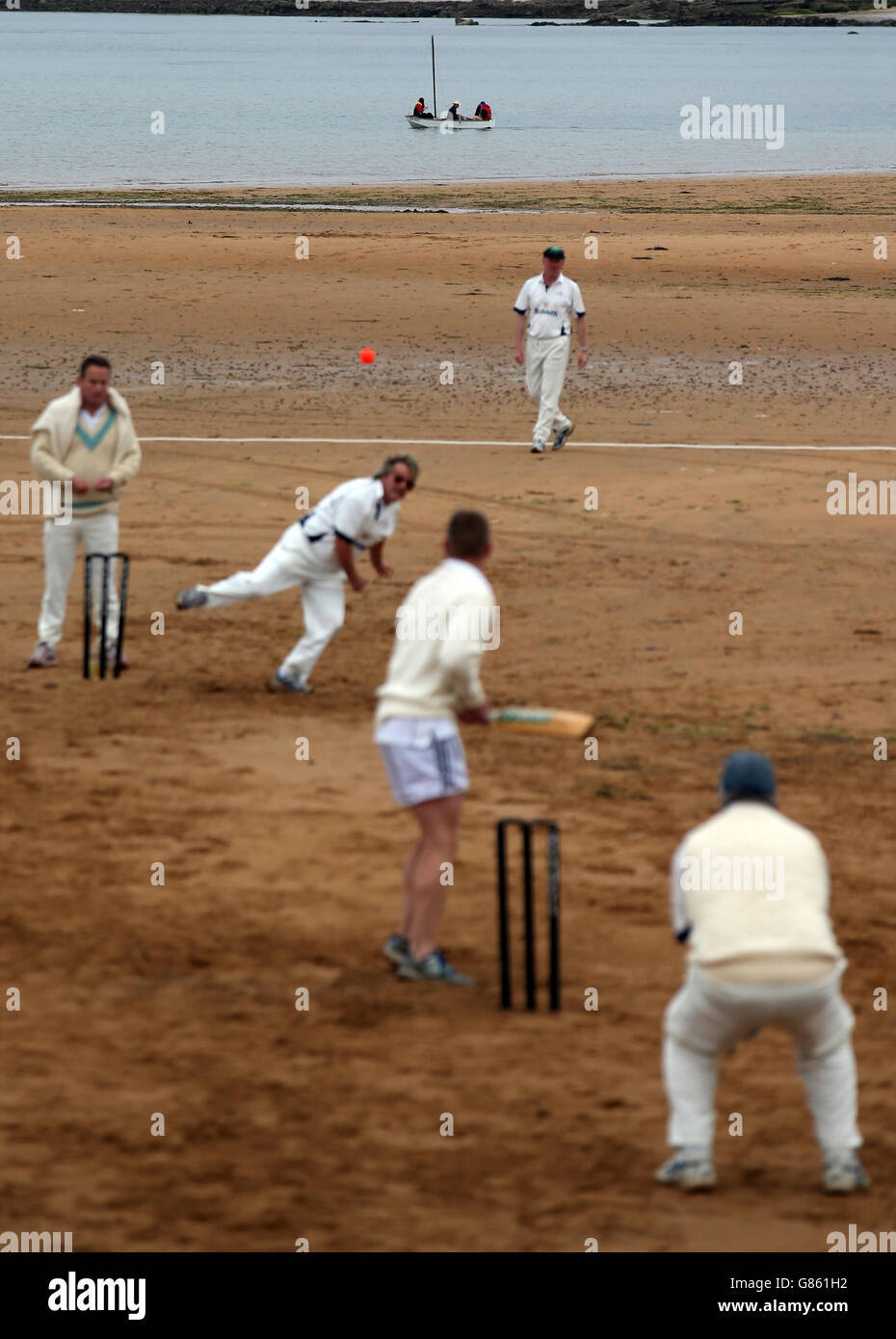 Beach cricket. Action from the Ship Inn Cricket team against Obolensky ...