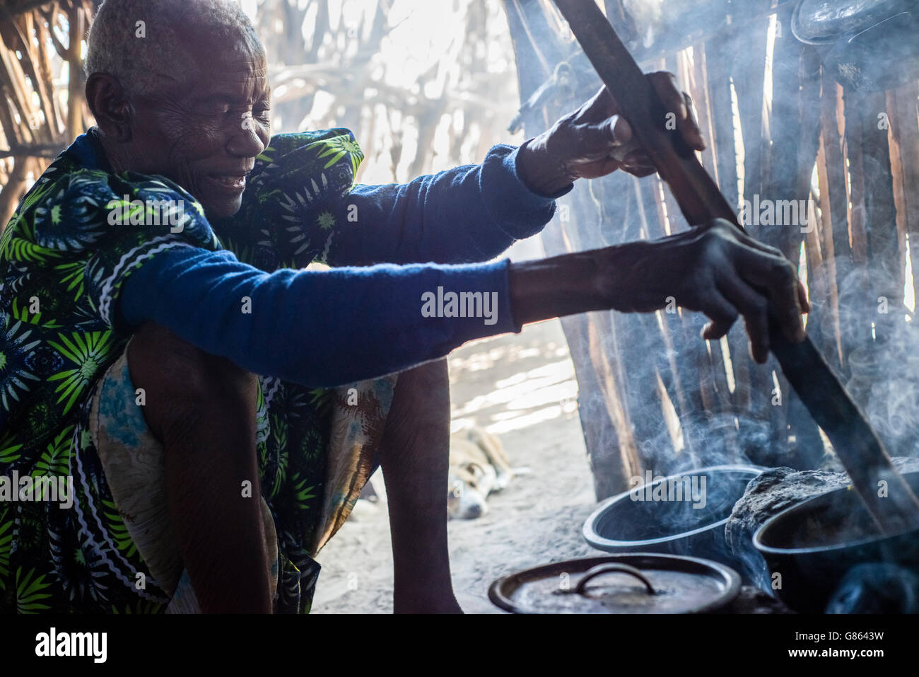 Ovambo woman prepares food on fire in her kitchen, Oshipanda village ...