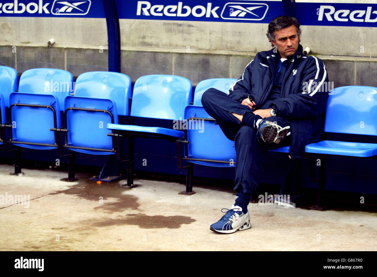 Chelsea's manager Jose Mourinho sits alone on the bench before the game ...