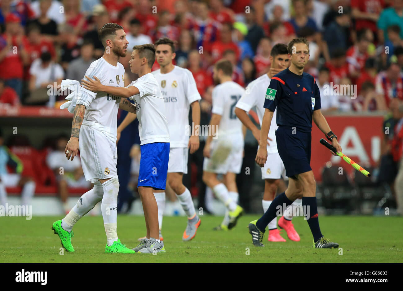 A young fan attempts to embrace Real Madrid's captain Sergio Ramos ...