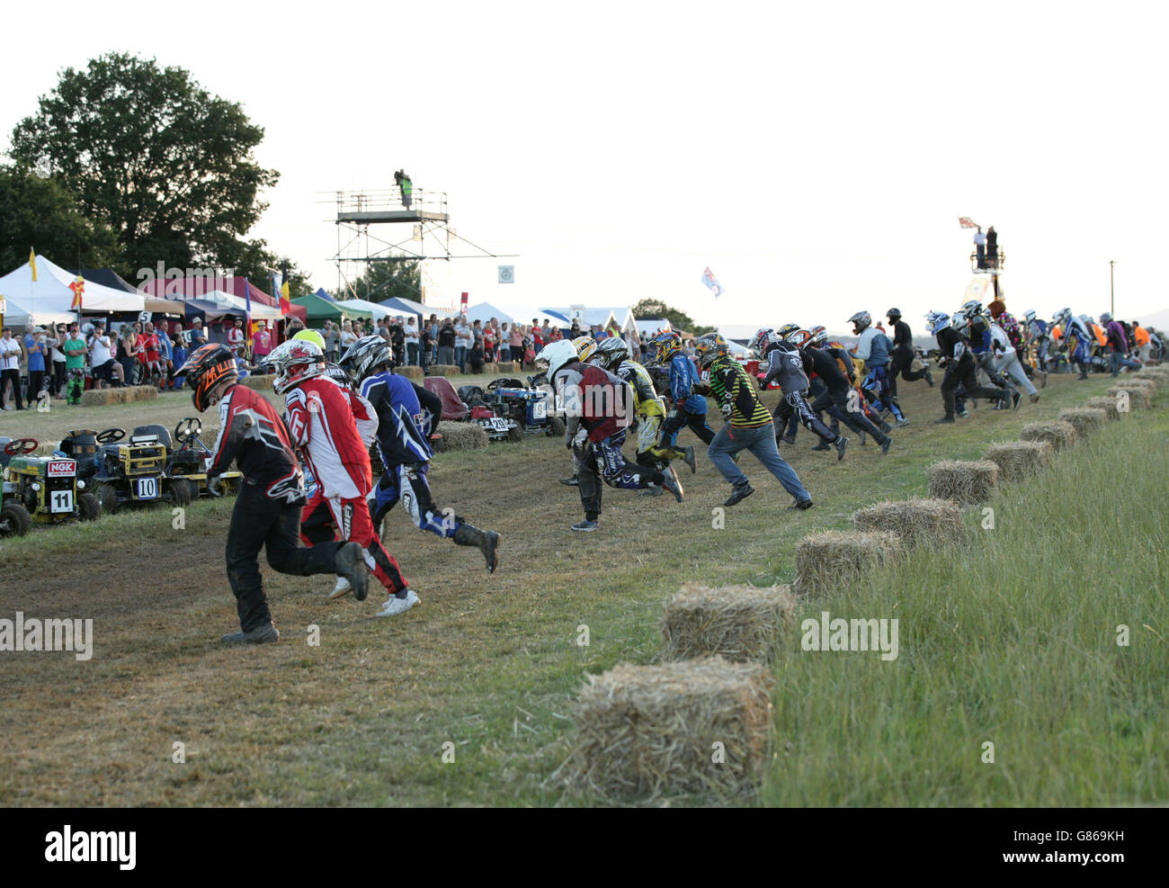 Competitors run towards their mowers at the start of the British Lawn ...