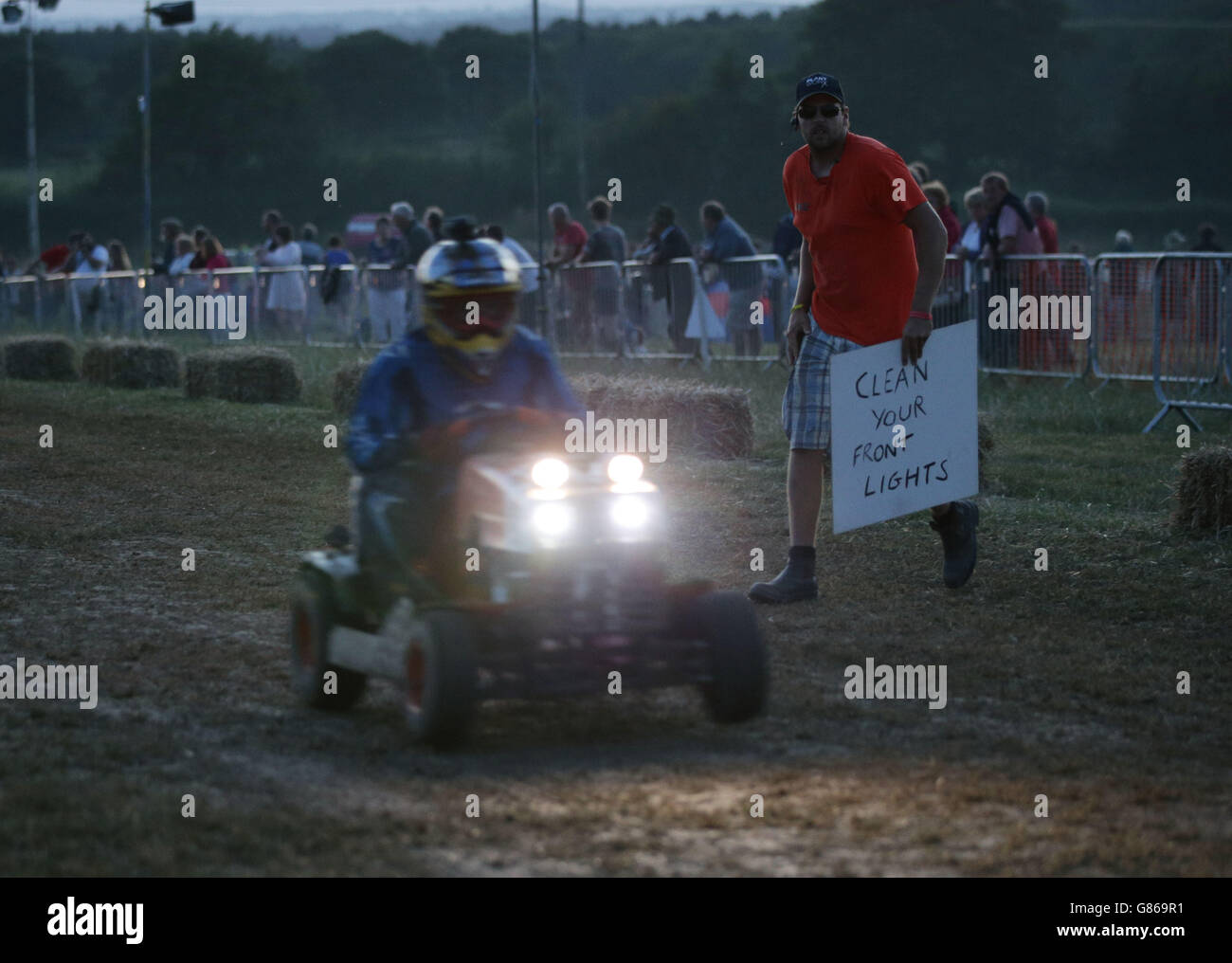 Drivers on their lawnmowers racing into the night hi-res stock ...