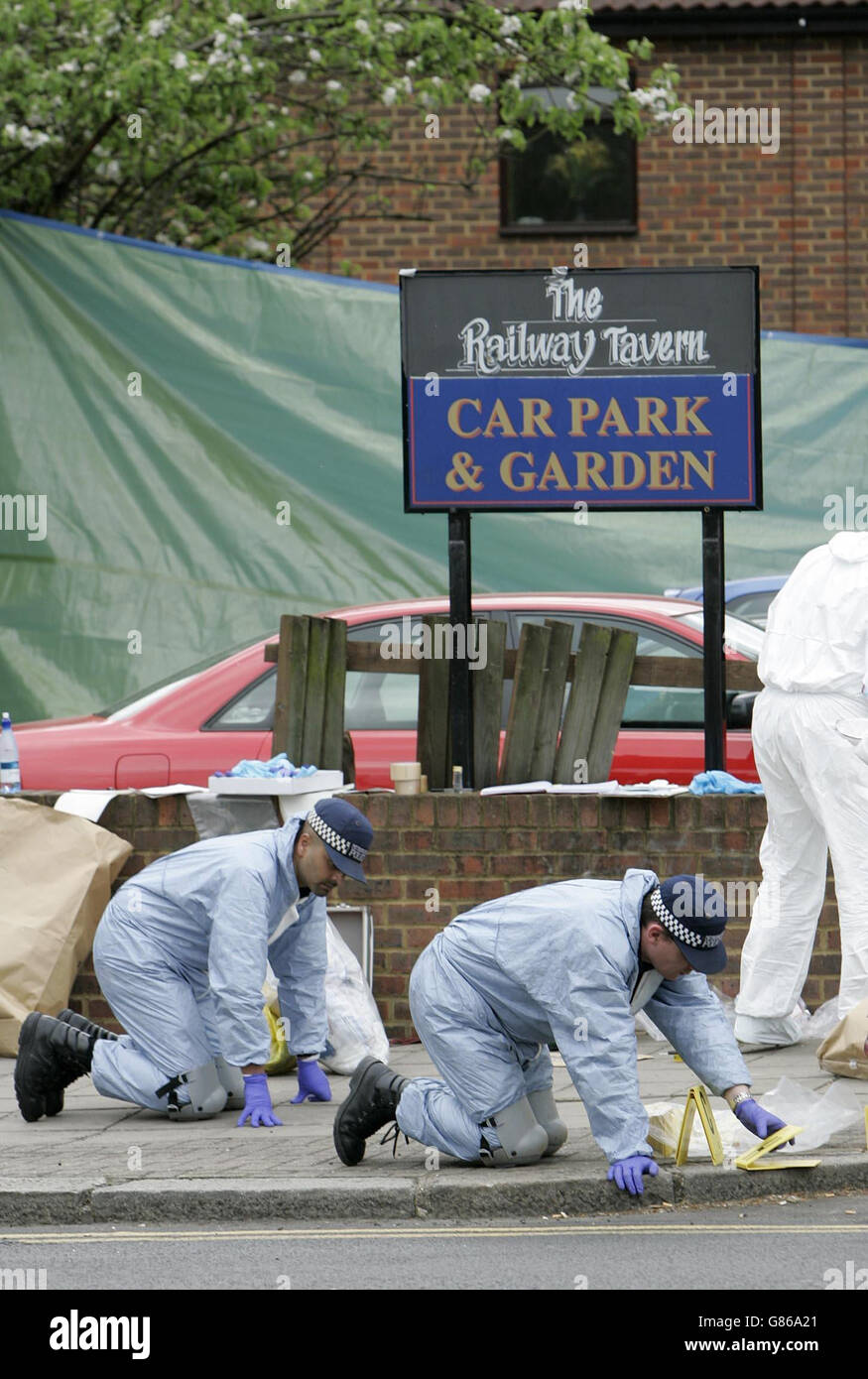Police forensics team searching outside The Railway Tavern at the scene ...