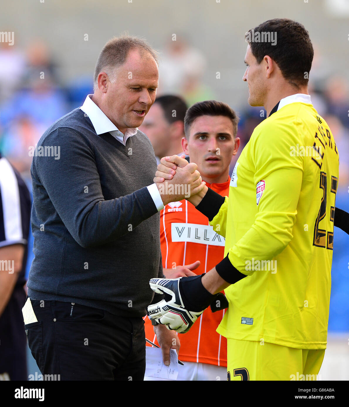 Blackpool manager Neil McDonald shakes hands with Blackpool goalkeeper ...
