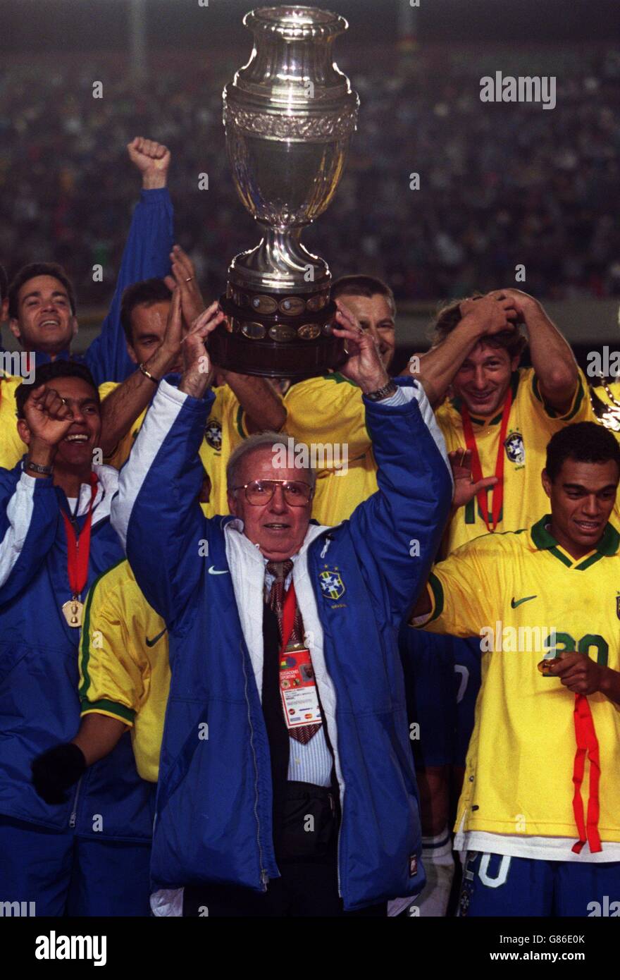 Brazil manager, Mario Jorge Zagallo, holds the Copa America trophy ...