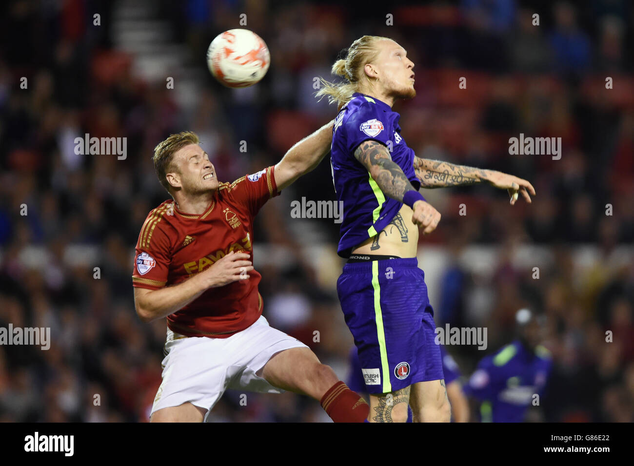 Charlton Athletic's Simon Makienok (right) wins the ball ahead of ...