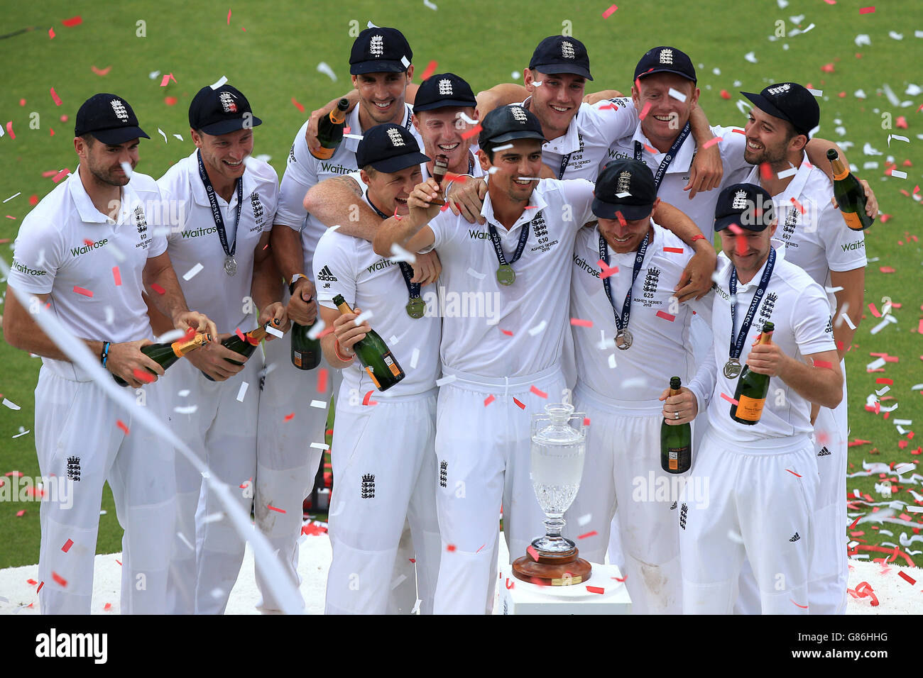 England captain Alastair Cook (centre) lifts the Ashes urn as they ...