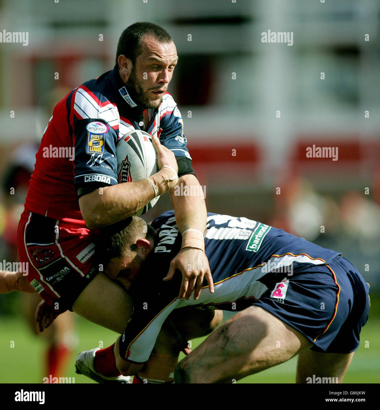 Salford Reds' Ian Sibbit is tackled by London Bronchos' Rob Purdham ...
