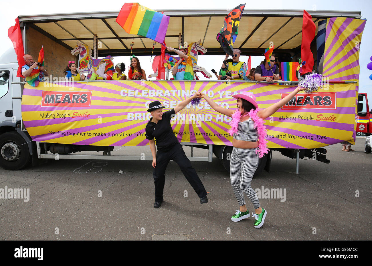 A police officer enjoys the Brighton Pride festival parade as it makes ...