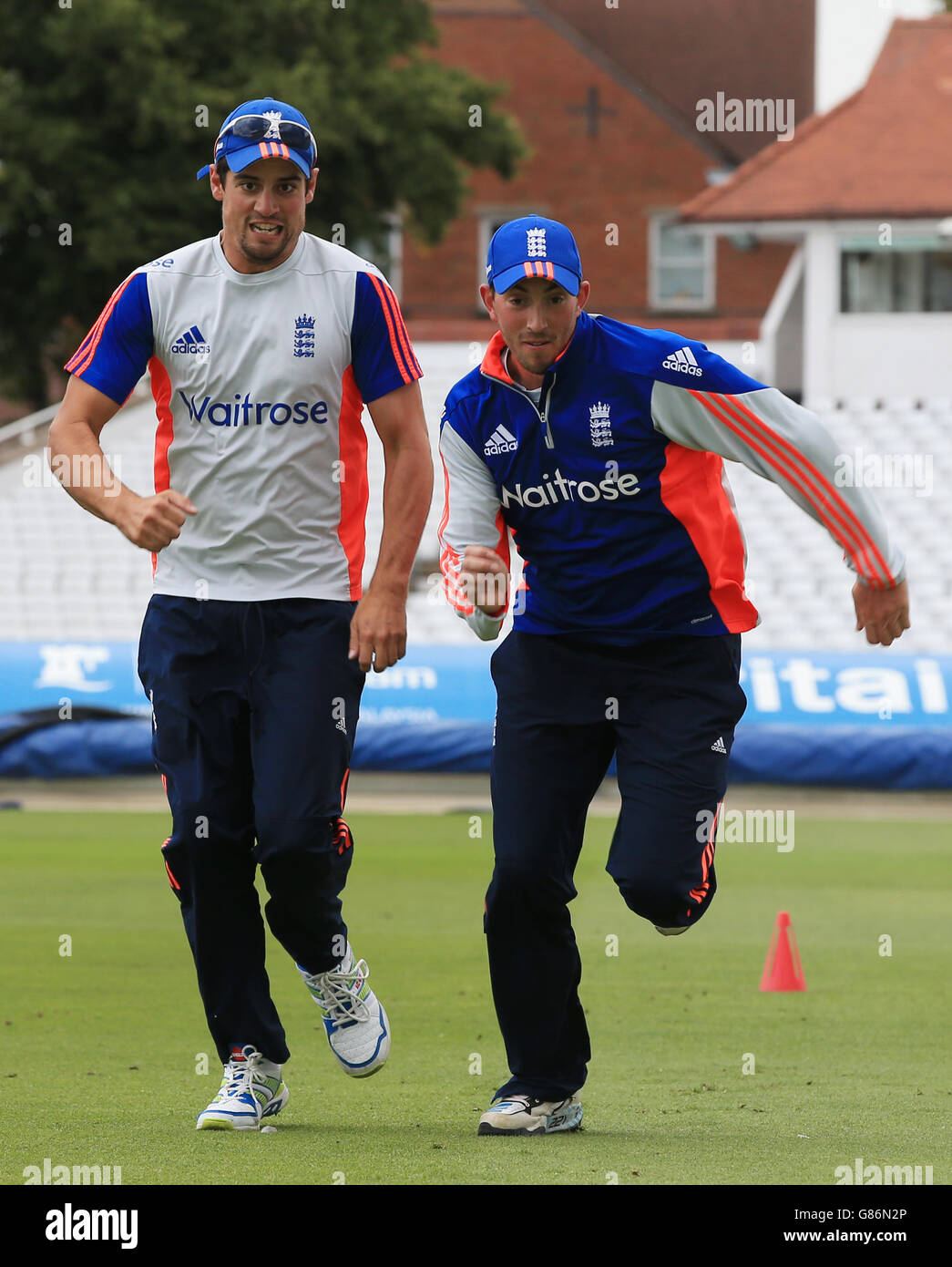 England captain Alastair Cook warms up with Mark Footitt (right) during ...