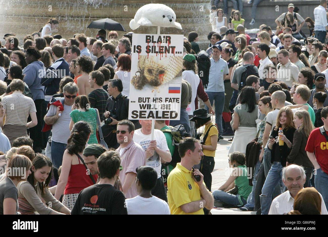 A May Day protestor walks through the crowd of tourists and rally ...