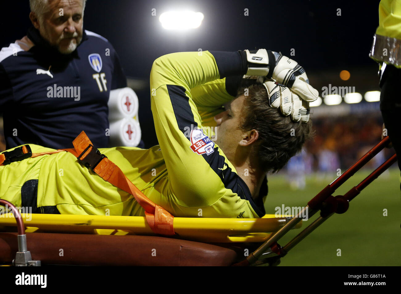 Colchester United goalkeeper Sam Walker goes off injured Stock Photo ...