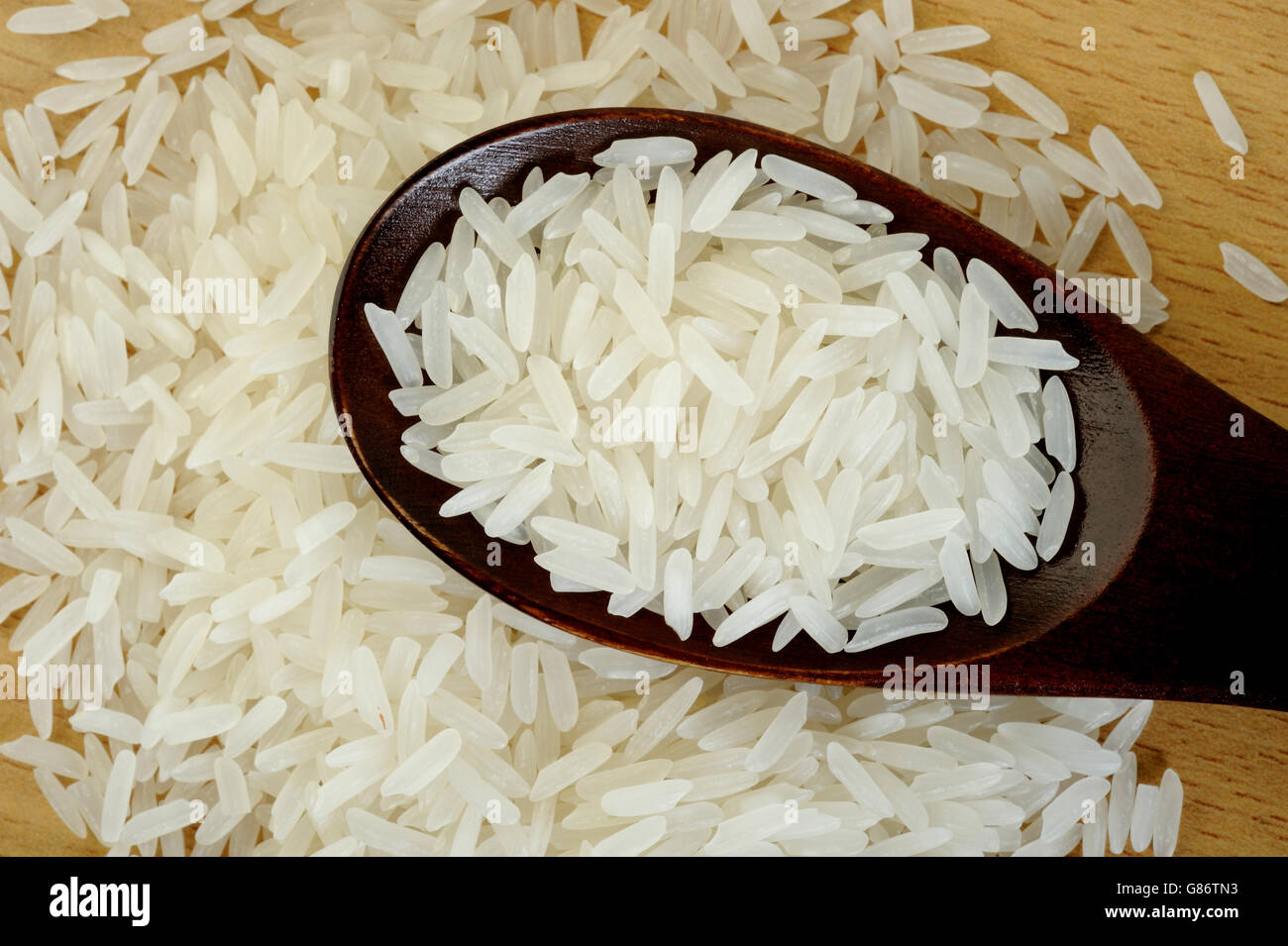 rice in wooden spoon Stock Photo - Alamy