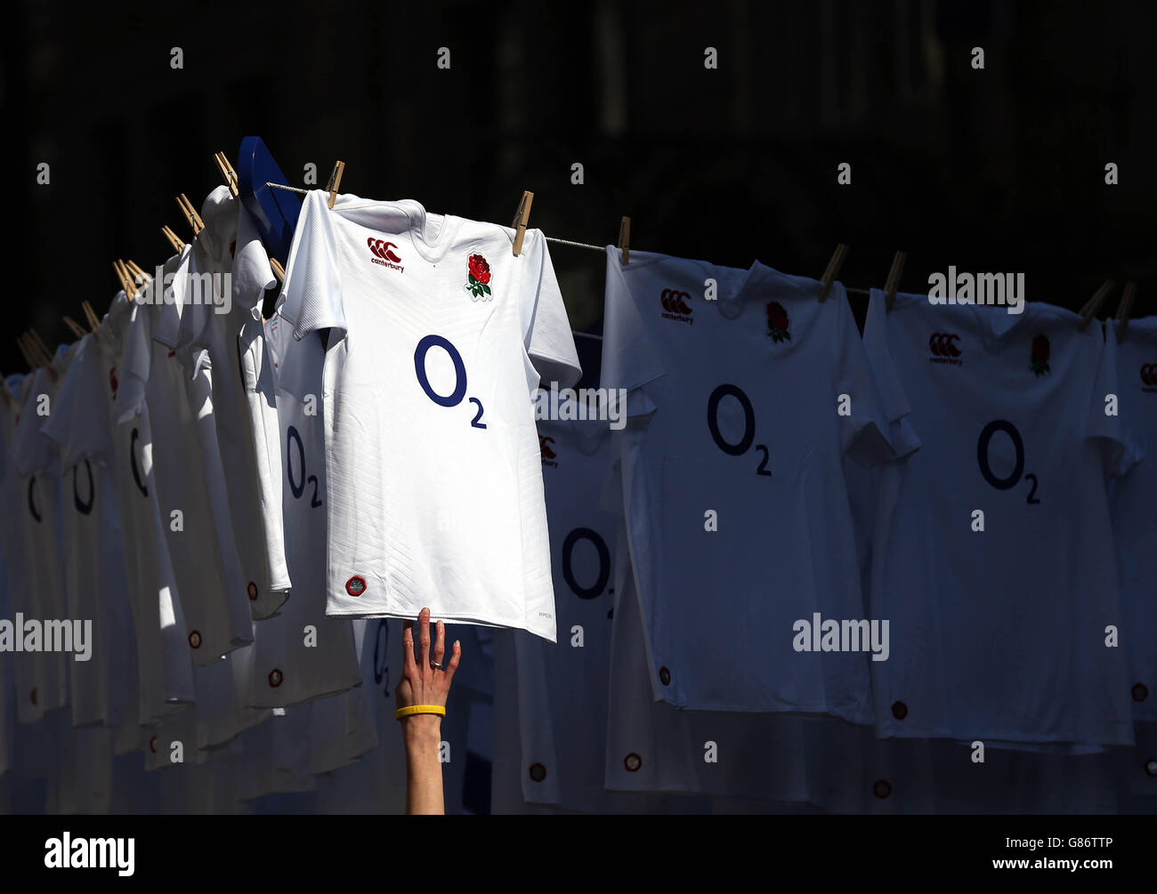 A member of the public grabs a rugby shirt during the O2 #WearTheRose ...