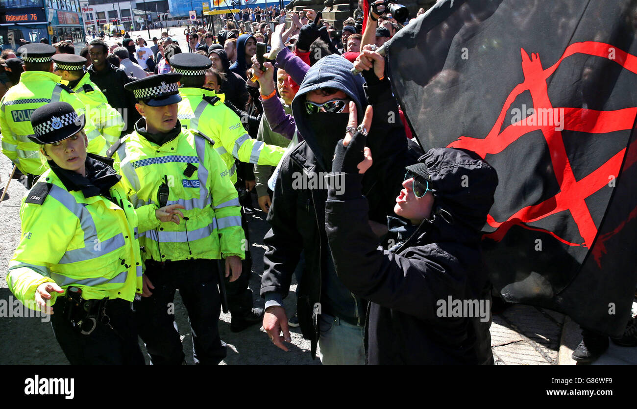EDITORS NOTE GESTURE A woman holding an anarchist flag gestures as ...