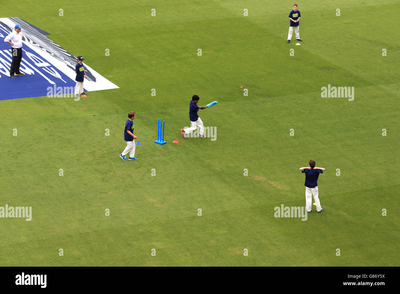 Young fans play cricket on outfield hi-res stock photography and images ...
