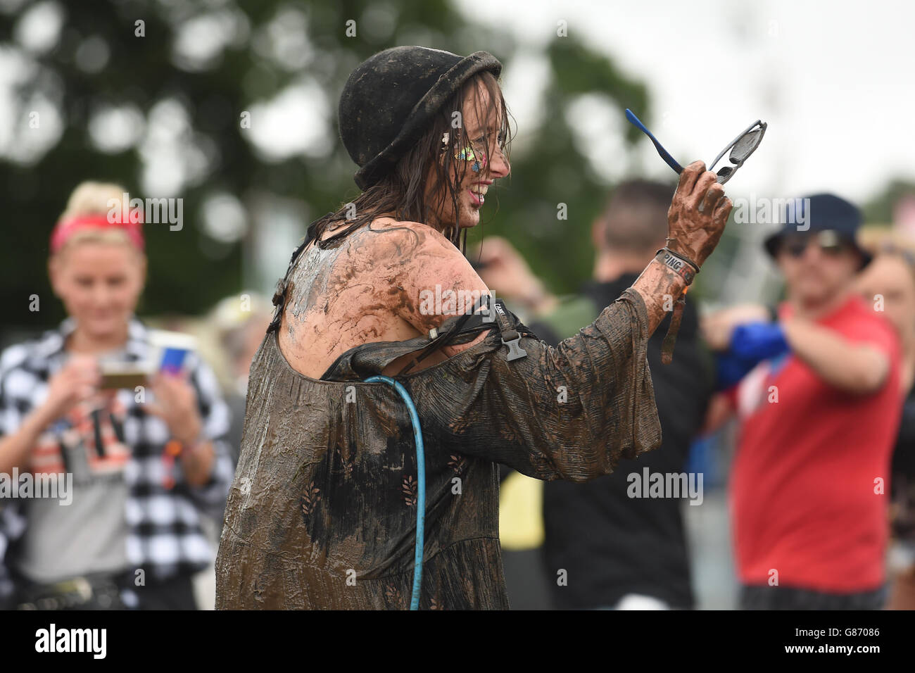 A festival goer covered in mud during day two of the V Festival, at ...