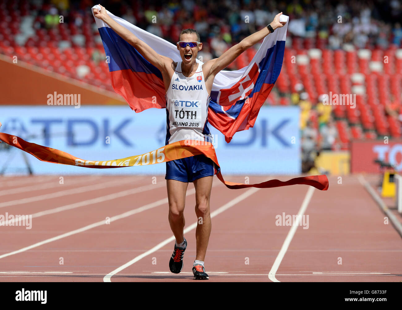 Slovakia's Matej Toth celebrates winning the Men's 50km Race Walk ...